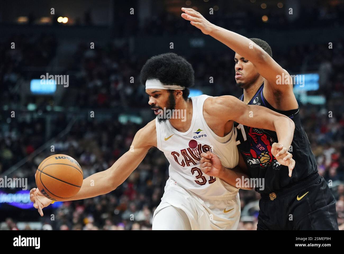 Cleveland Cavaliers' Jarrett Allen, left, protects the ball from ...