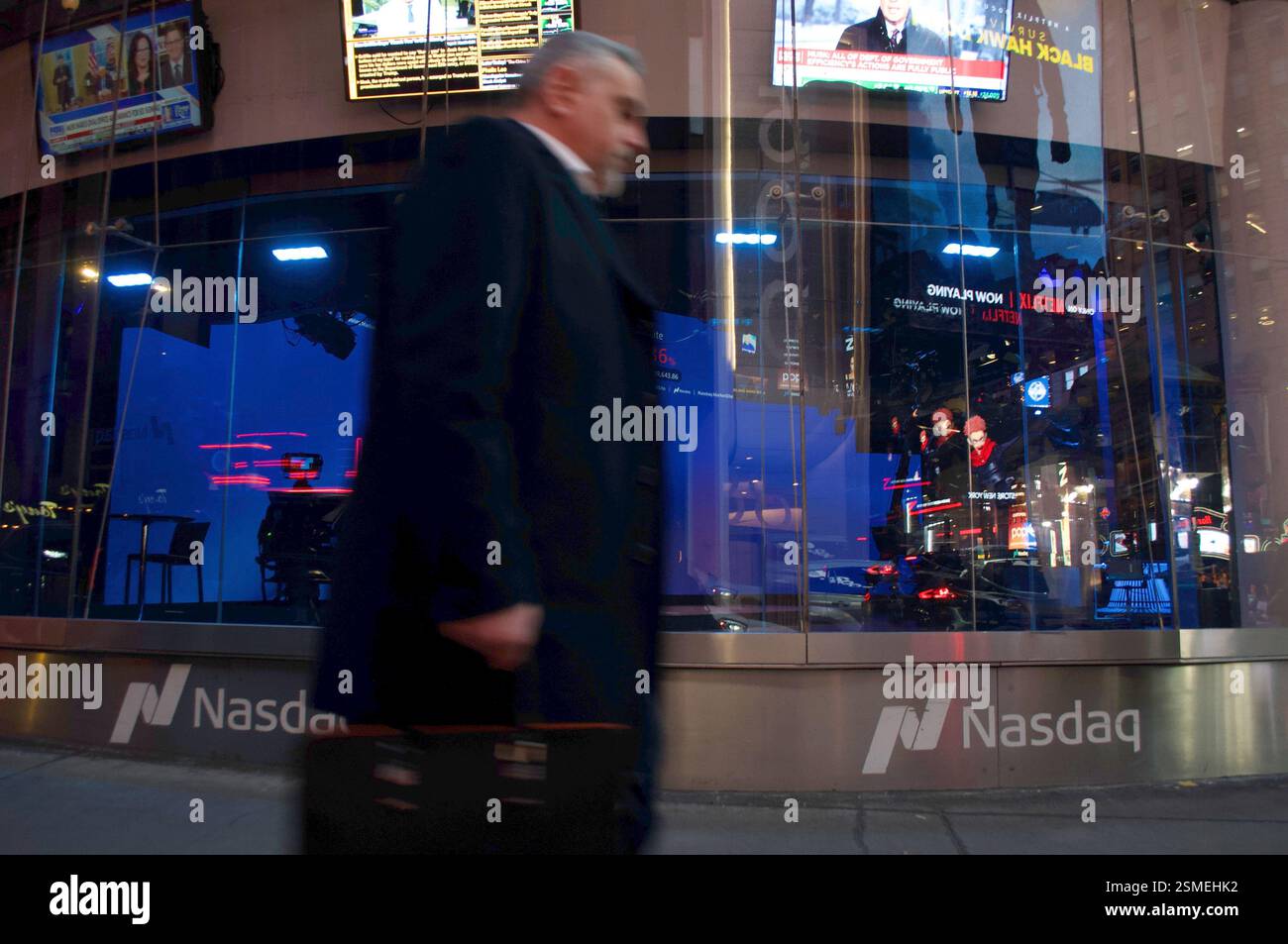 New York, United States. 11th Feb, 2025. A person walks past the Nasdaq ...
