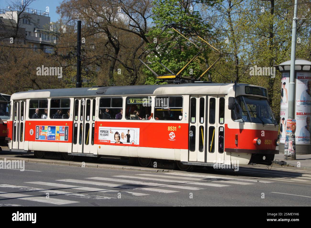 Tram in Prague. Red and white tram with multiple windows and people ...