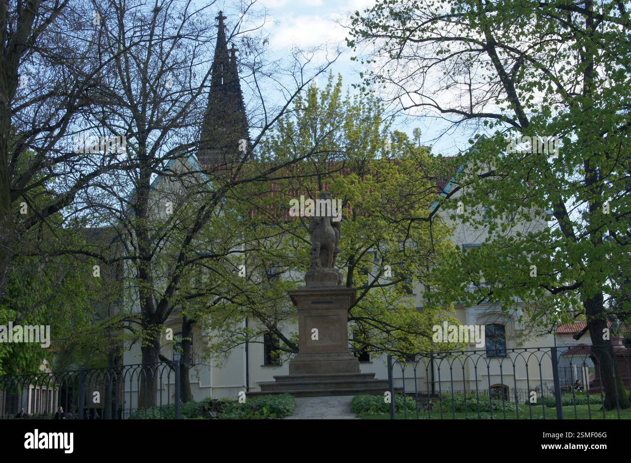 Statue of a man in military uniform. Background features a church with ...