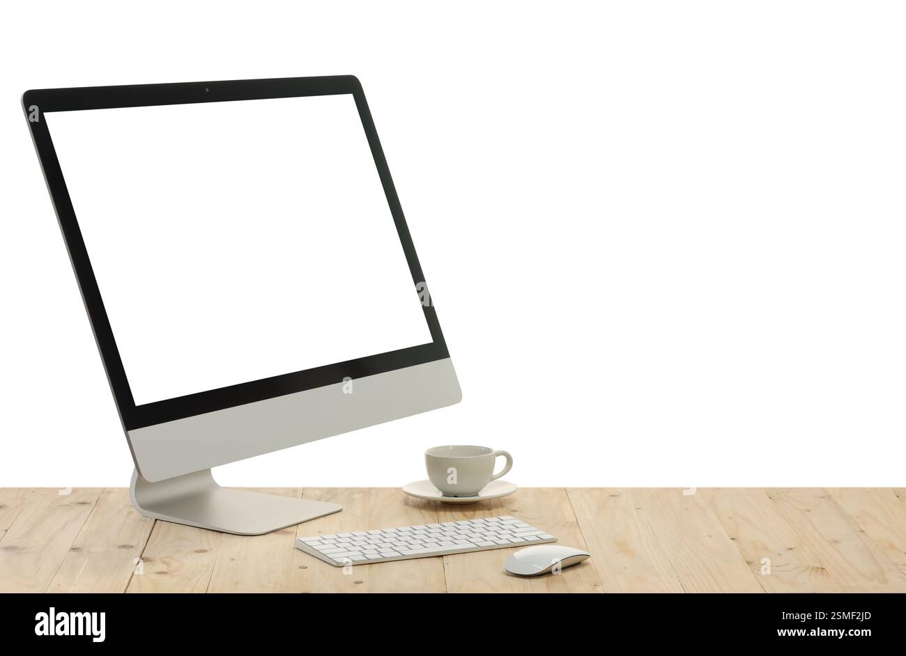 Computer monitor, keyboard, mouse and cup of drink on wooden desk ...