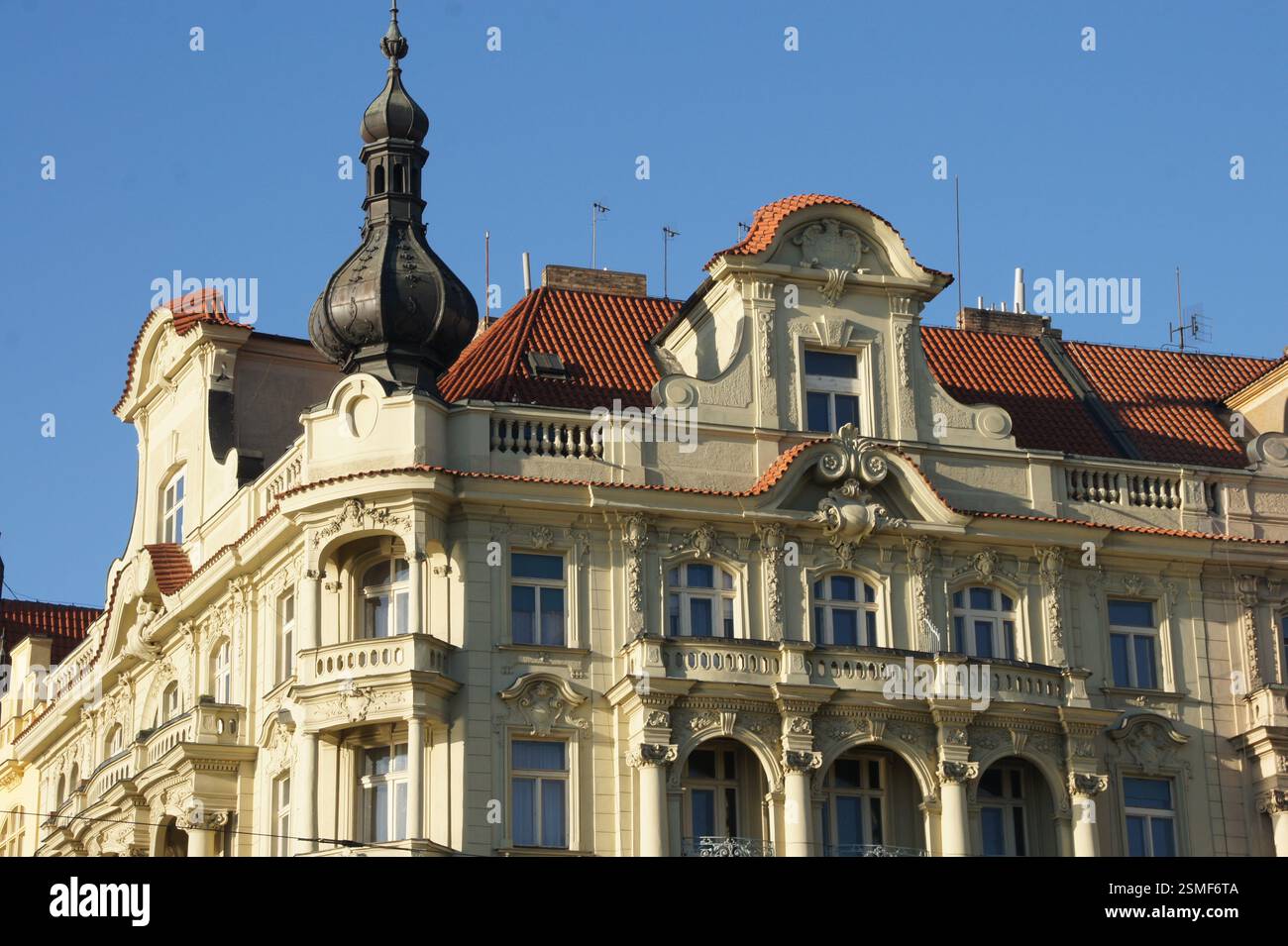 Eclectic architecture with ornate facade and red roof. Bohemian spirit ...
