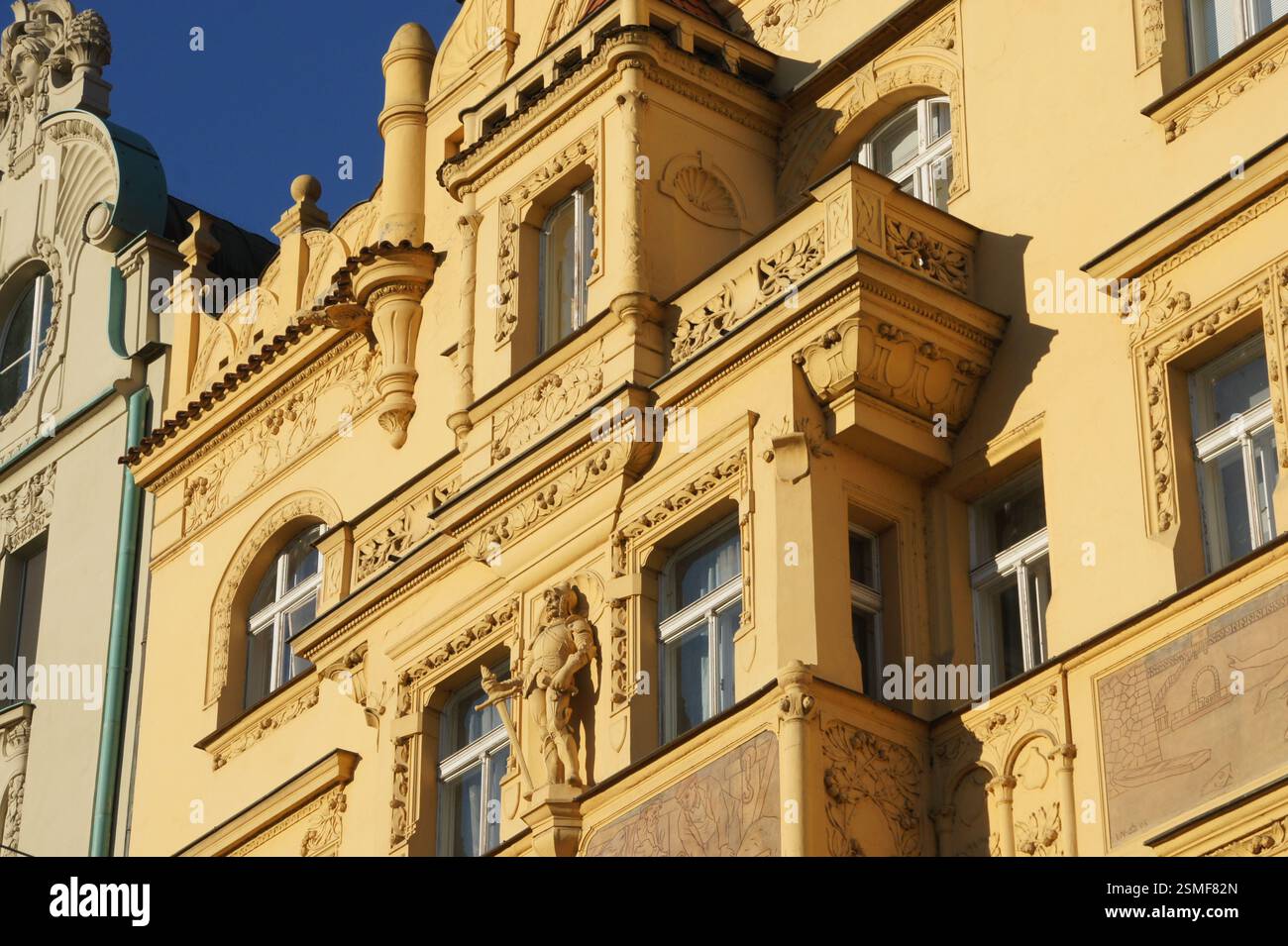 Facade. Yellow stucco building with ornate balconies and sculptures ...