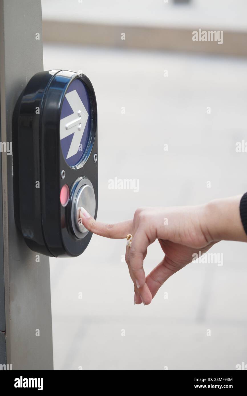 Hand pressing pedestrian crossing button in an urban setting Stock ...