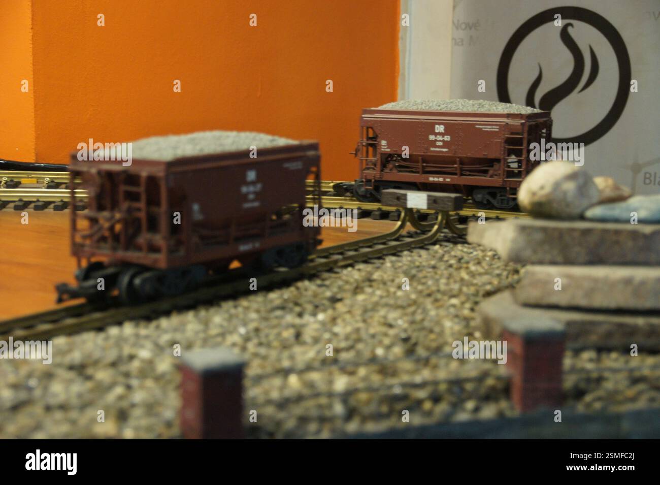 The Czech Republic. Two brown train cars on a track filled with gravel ...