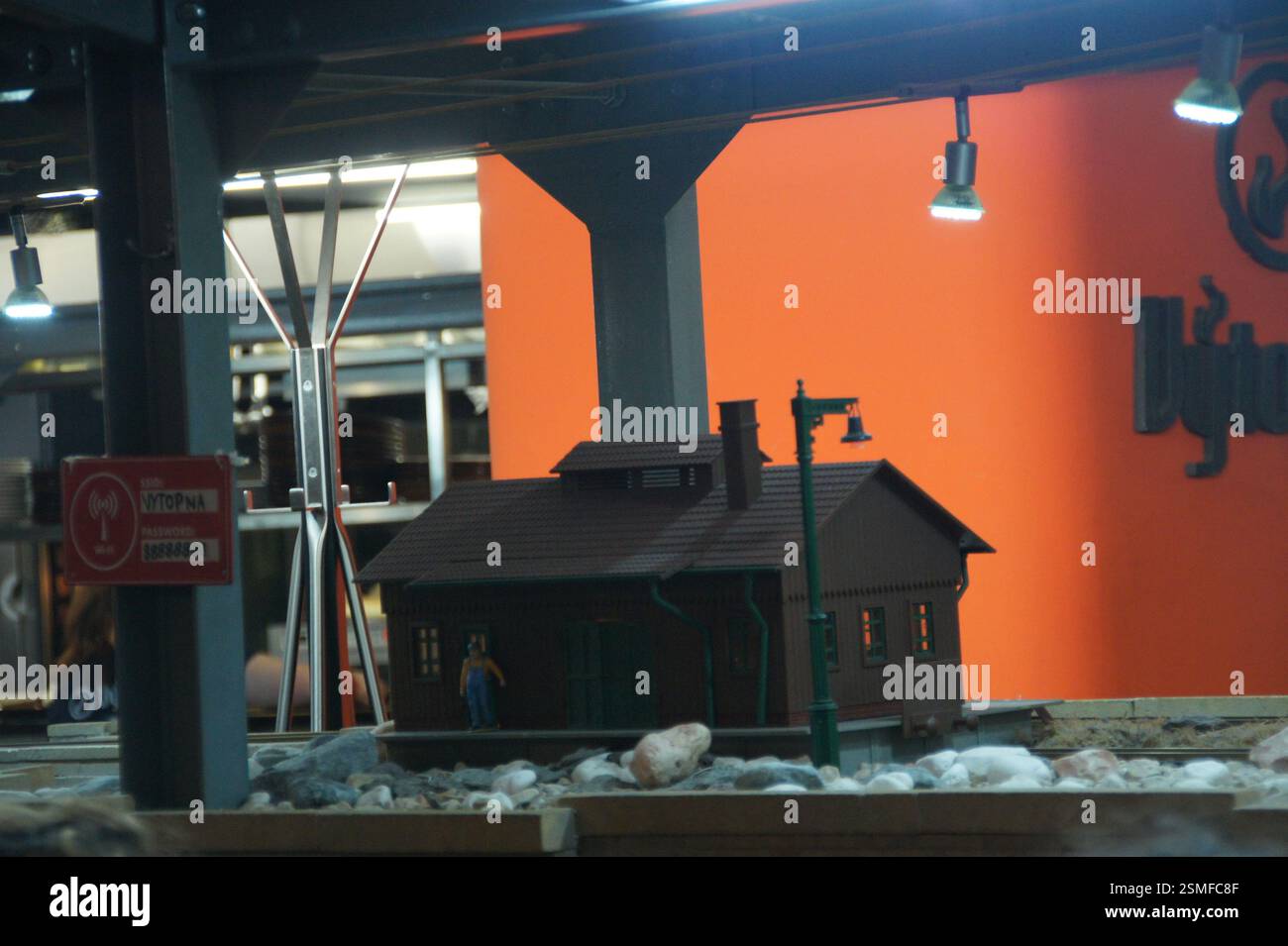 Model train layout with a miniature train station, landscape, and ...