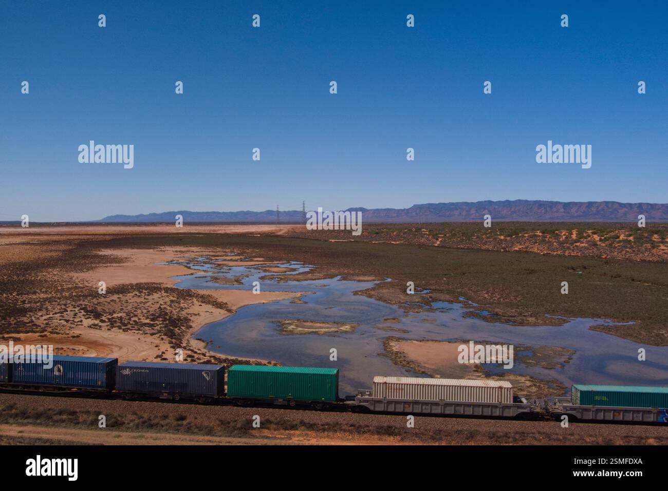 Aerial view of a freight train travelling through the outback region of ...