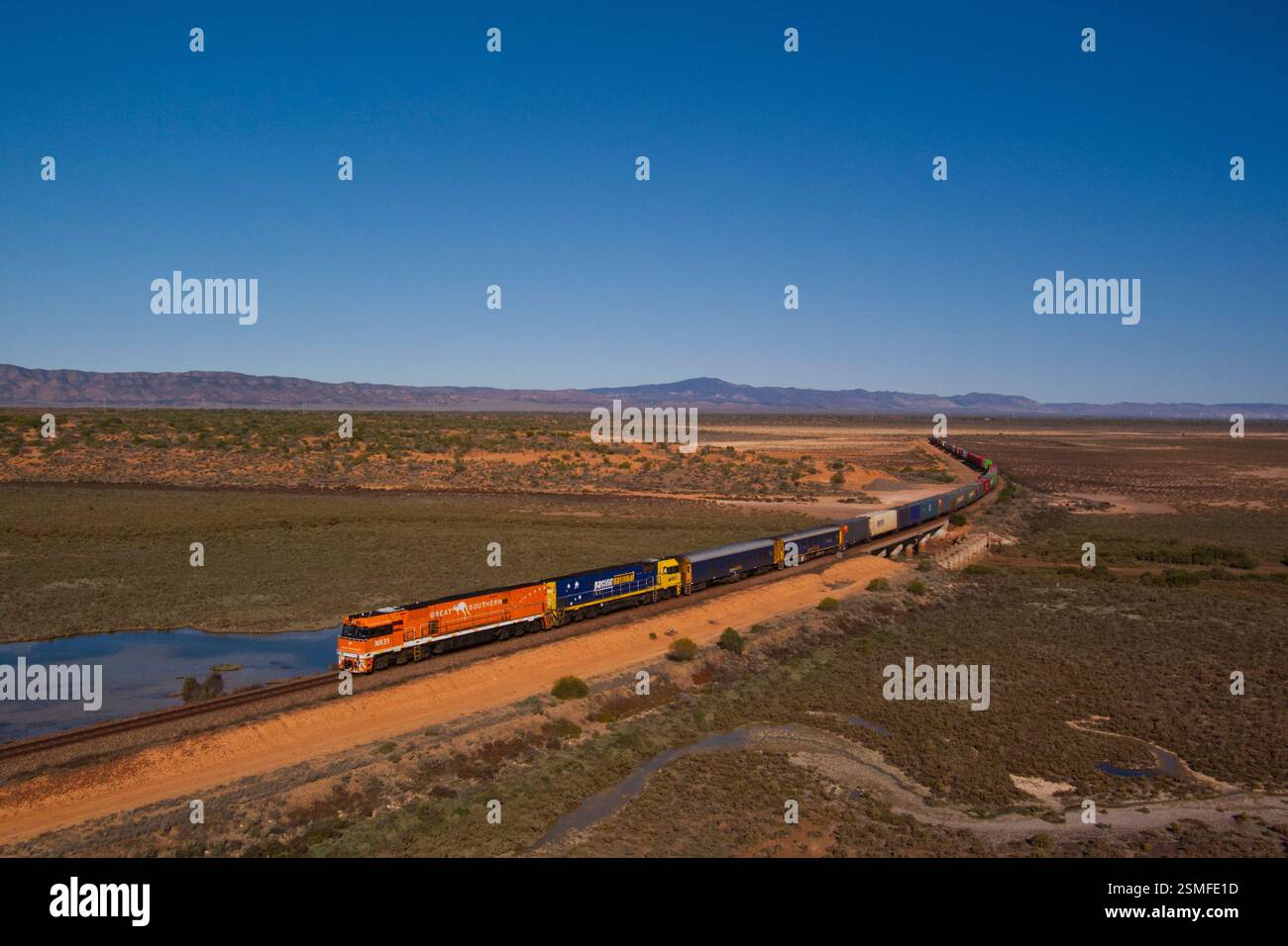Aerial view of a freight train travelling through the outback region of ...