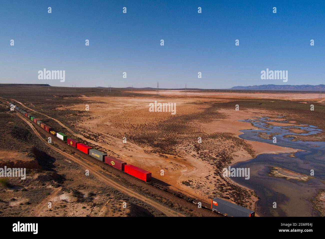 Aerial view of a freight train travelling through the outback region of ...