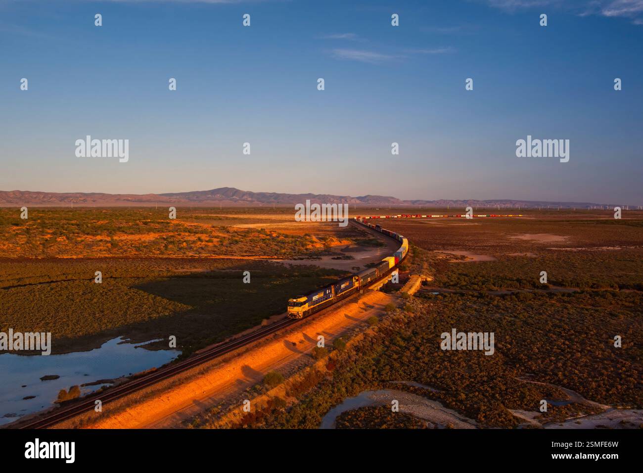 Aerial view of a freight train travelling through the outback region of ...