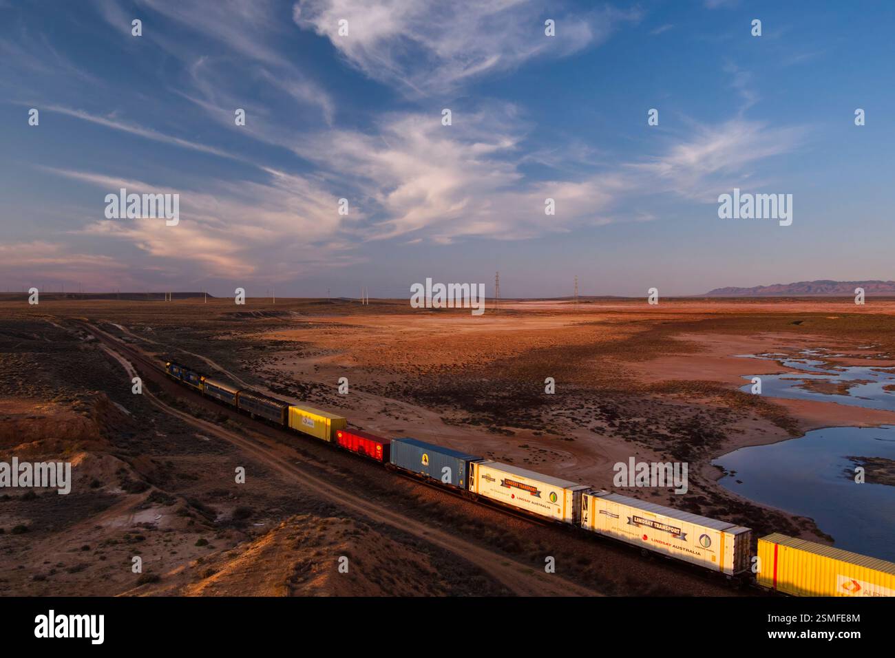 Aerial view of a freight train travelling through the outback region of ...