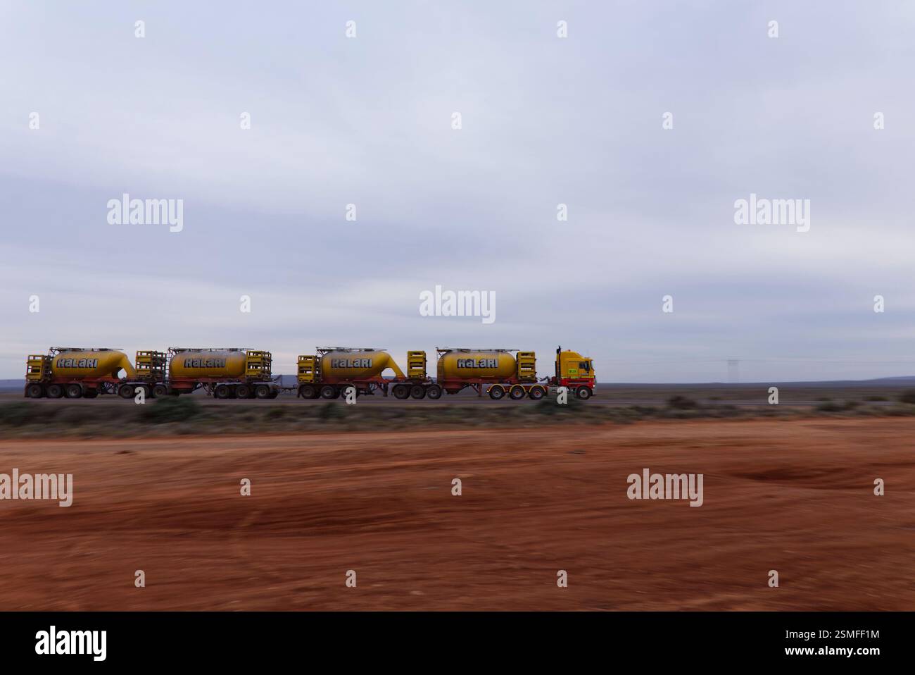 Side view of Pneumatic / Dry Bulk Tanker Road Train travelling on the ...