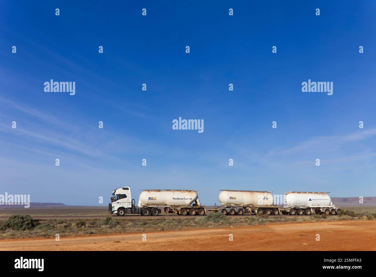 Side view of Pneumatic / Dry Bulk Tanker Road Train carrying dry cement ...