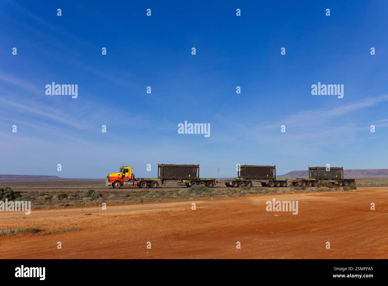 Side view of triple trailer Road Train travelling the Stuart highway in ...