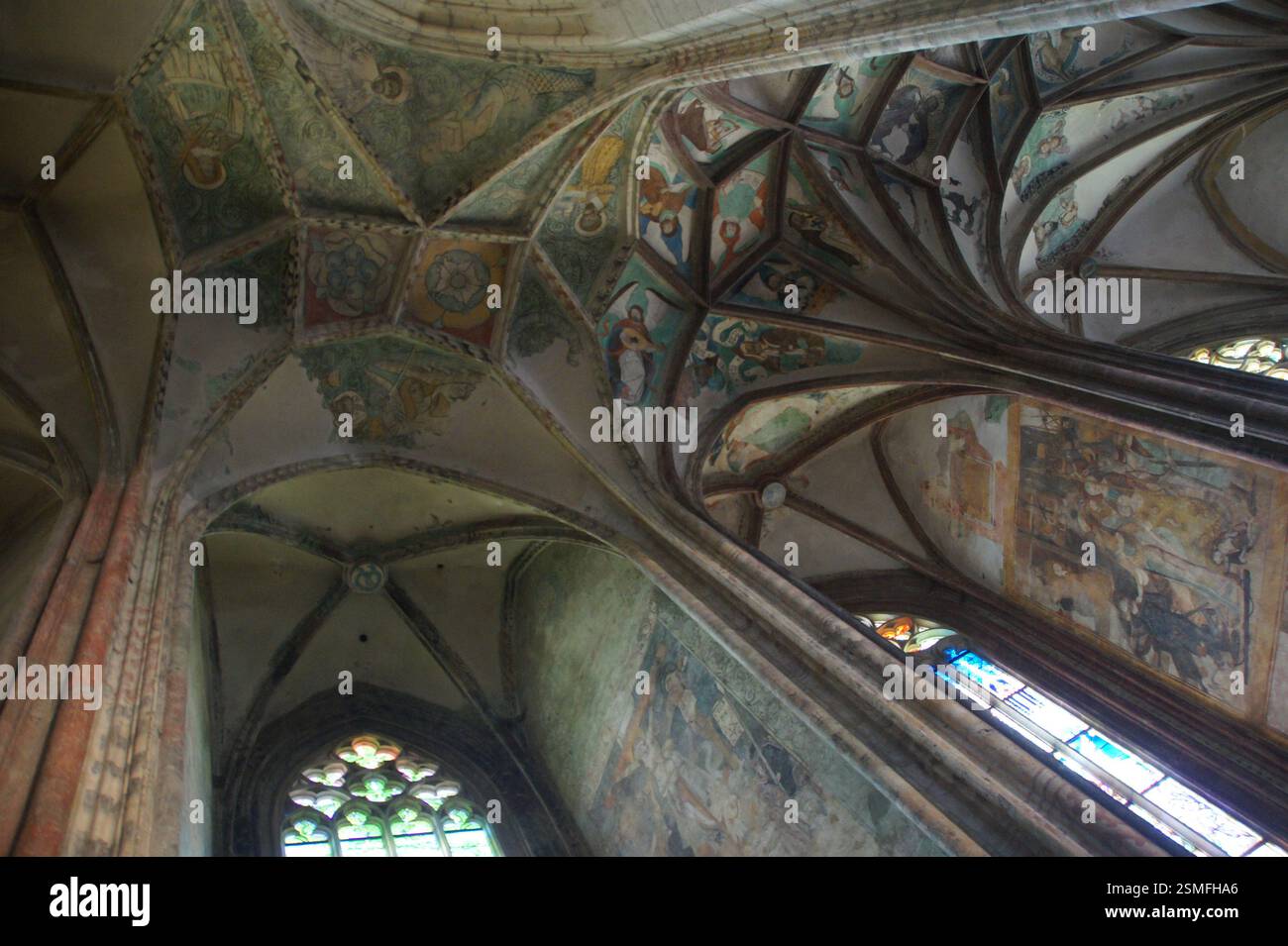 Gothic cathedral interior, Czech Republic. Ornate vaulted ceilings with painted murals. Stained ...
