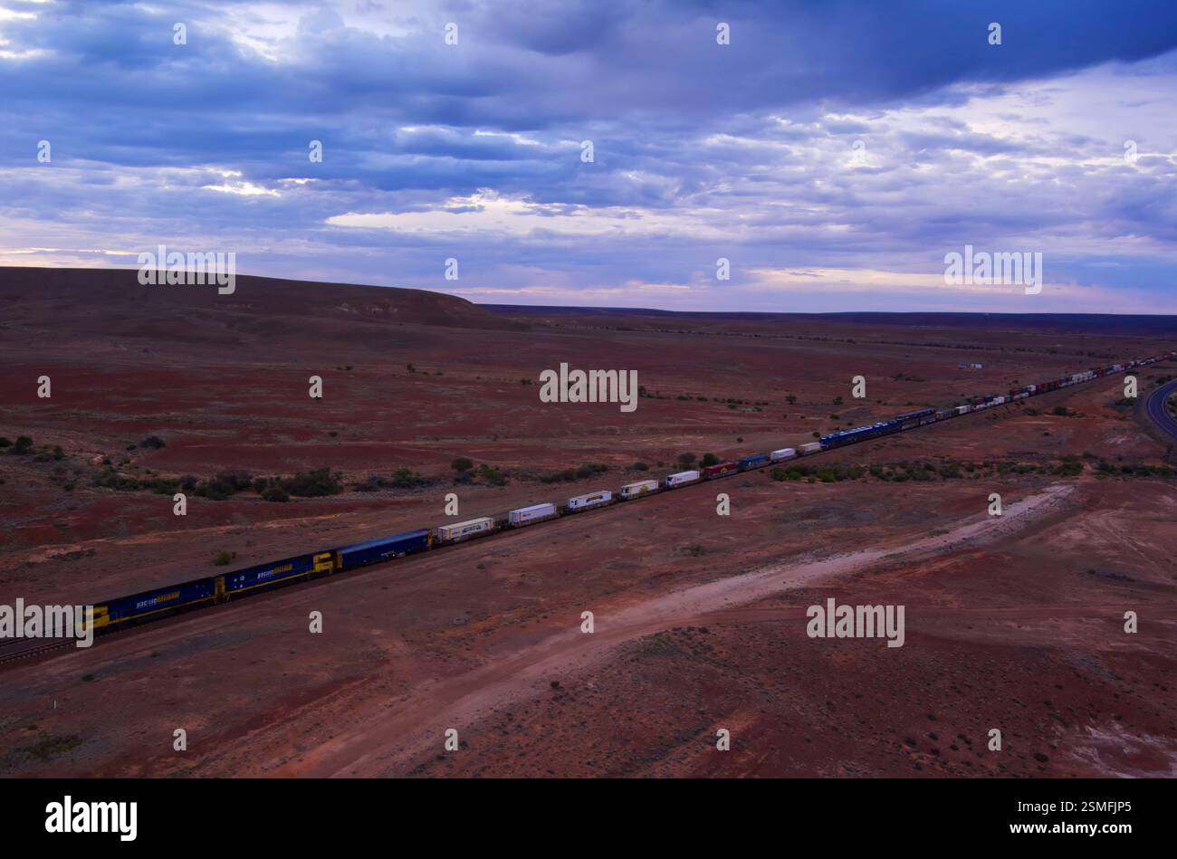 A freight train, composed of multiple cars and containers, is seen ...