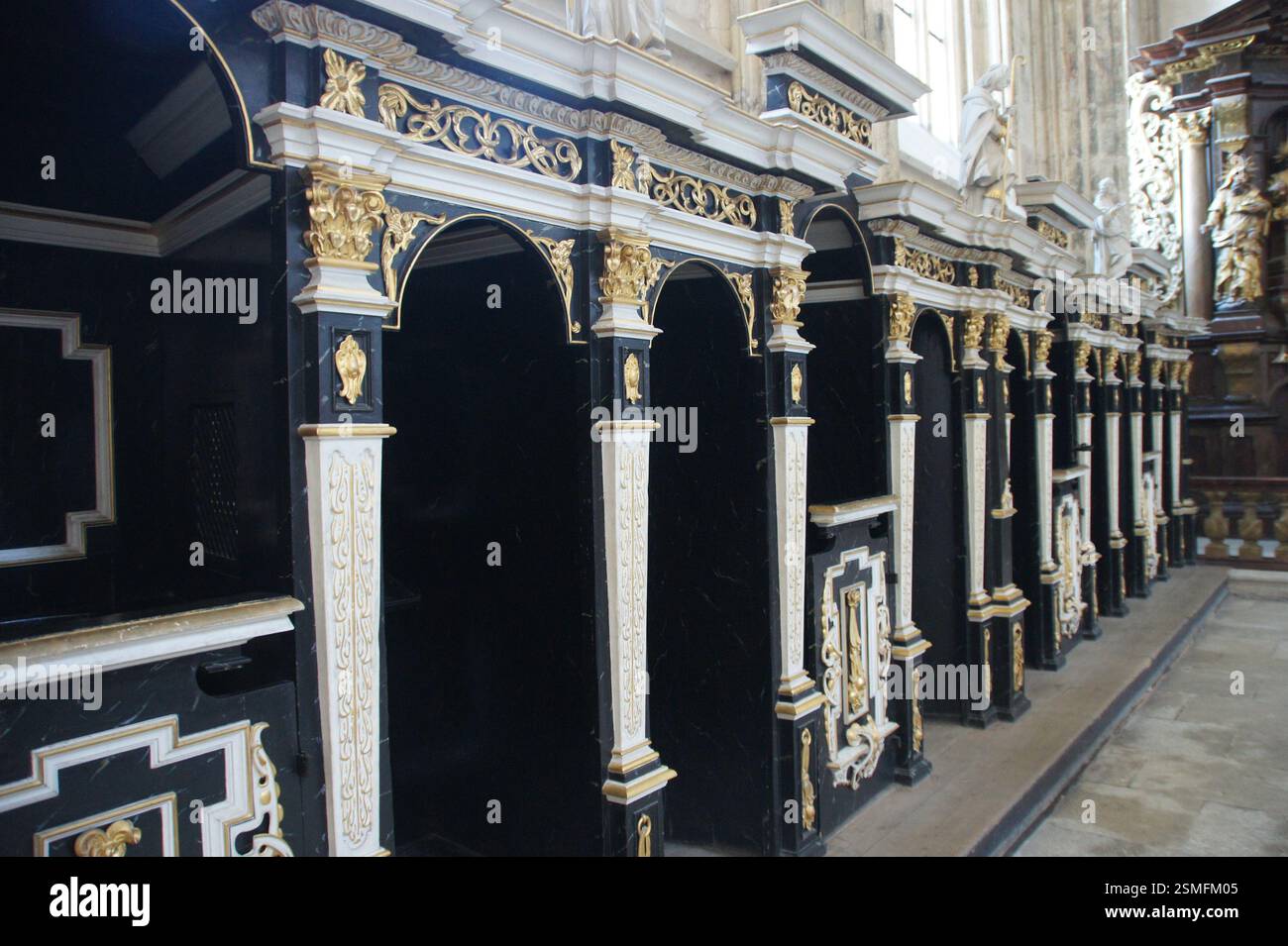 Church choir stalls, elaborate wood carvings, gold accents, dark color ...
