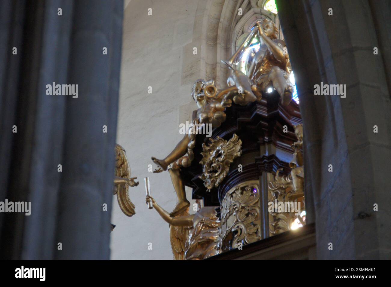 Ornate golden altar piece in the Czech Republic. Angels and cherubs ...