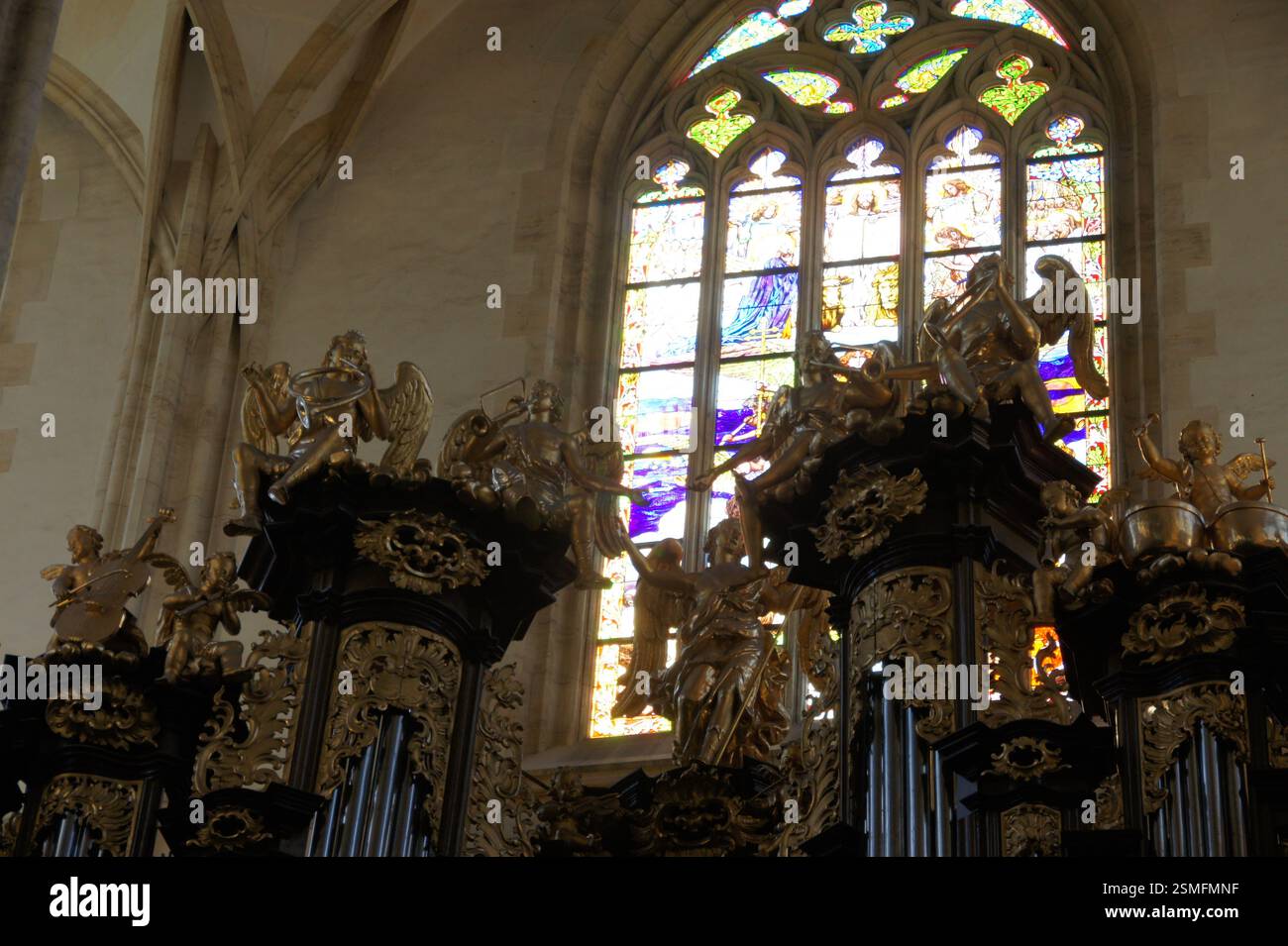 Czech Republic. Pipe organ. Ornate gold carvings frame the pipes ...