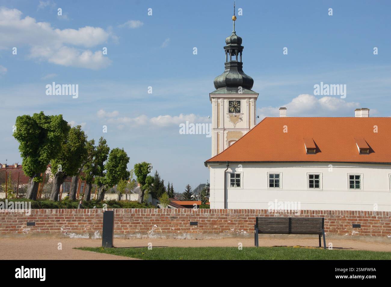 Jesuit College, Czech Republic. White building with red roof and clock ...