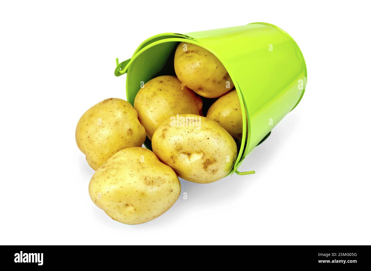A pile of yellow potatoes spilled out from a small green bucket ...