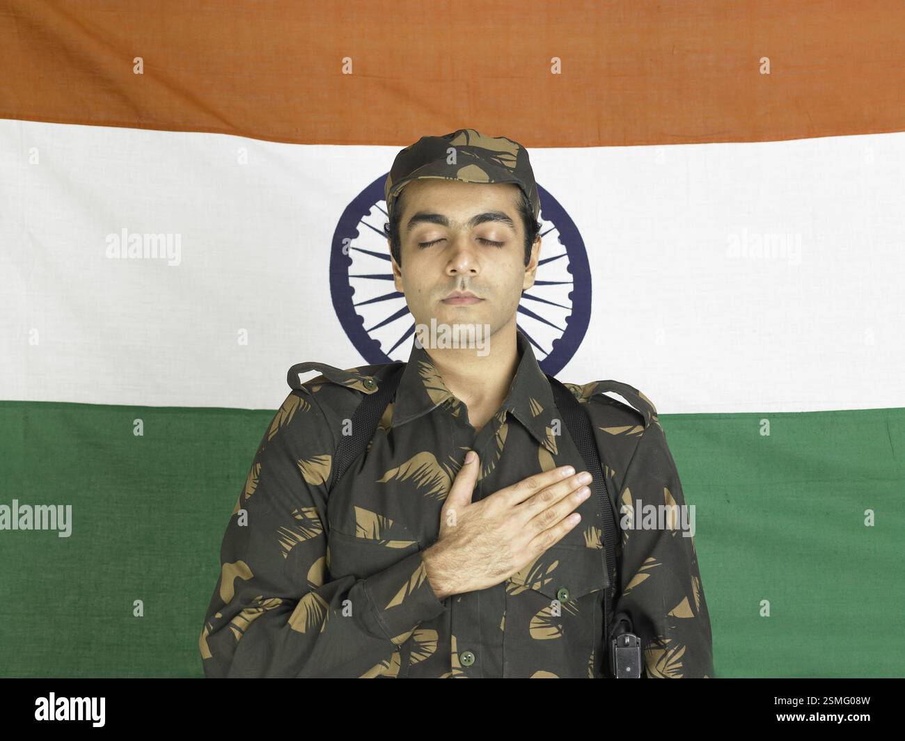 Indian army soldier taking oath in front of flag of India in background ...