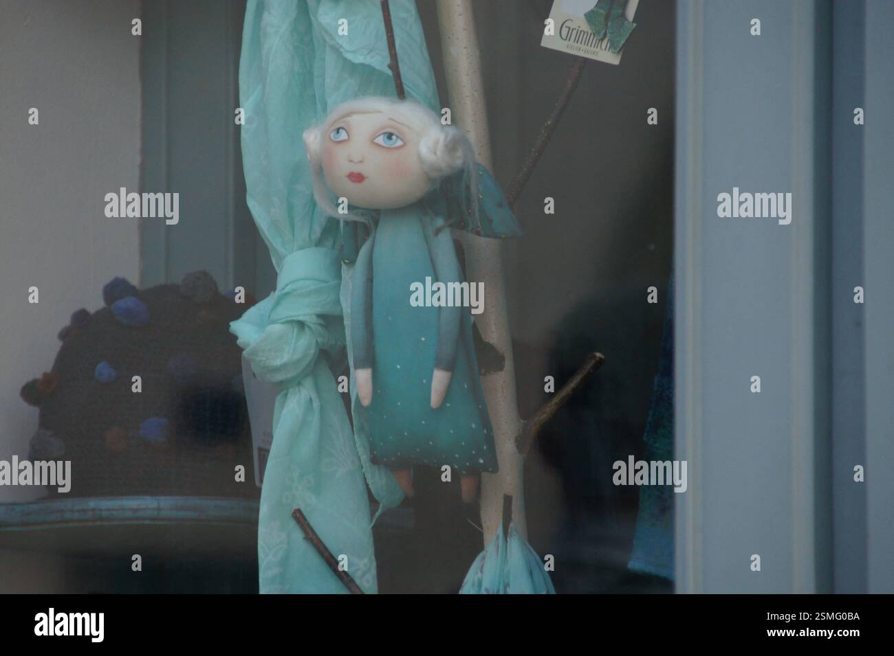 Rag doll blue dress white hair shop window. Sweet expression small blue ...