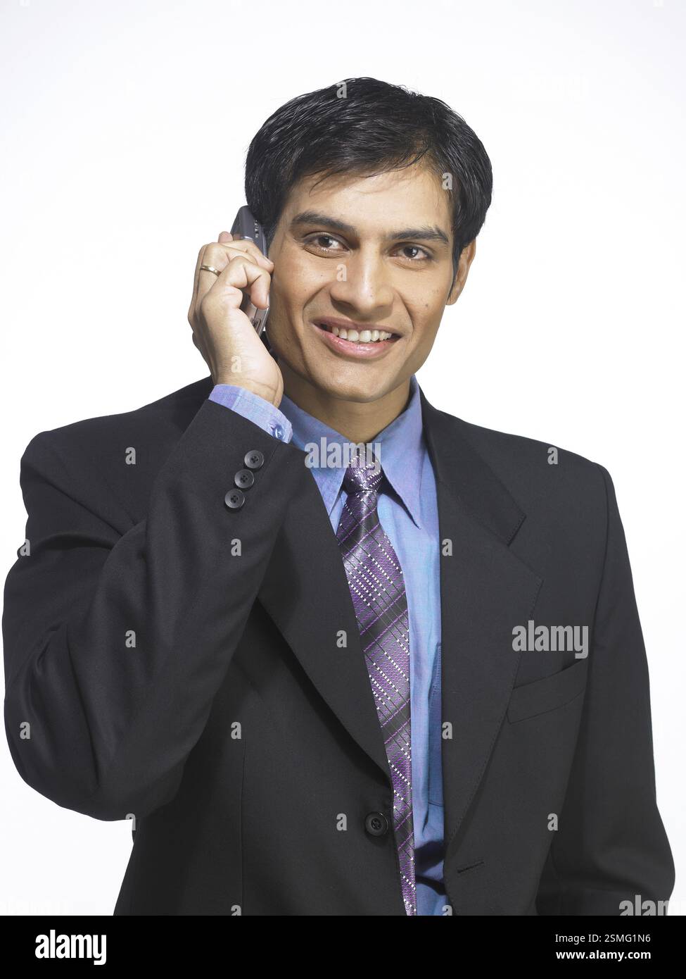 South Asian Indian executive man talking on mobile phone MR Stock Photo ...