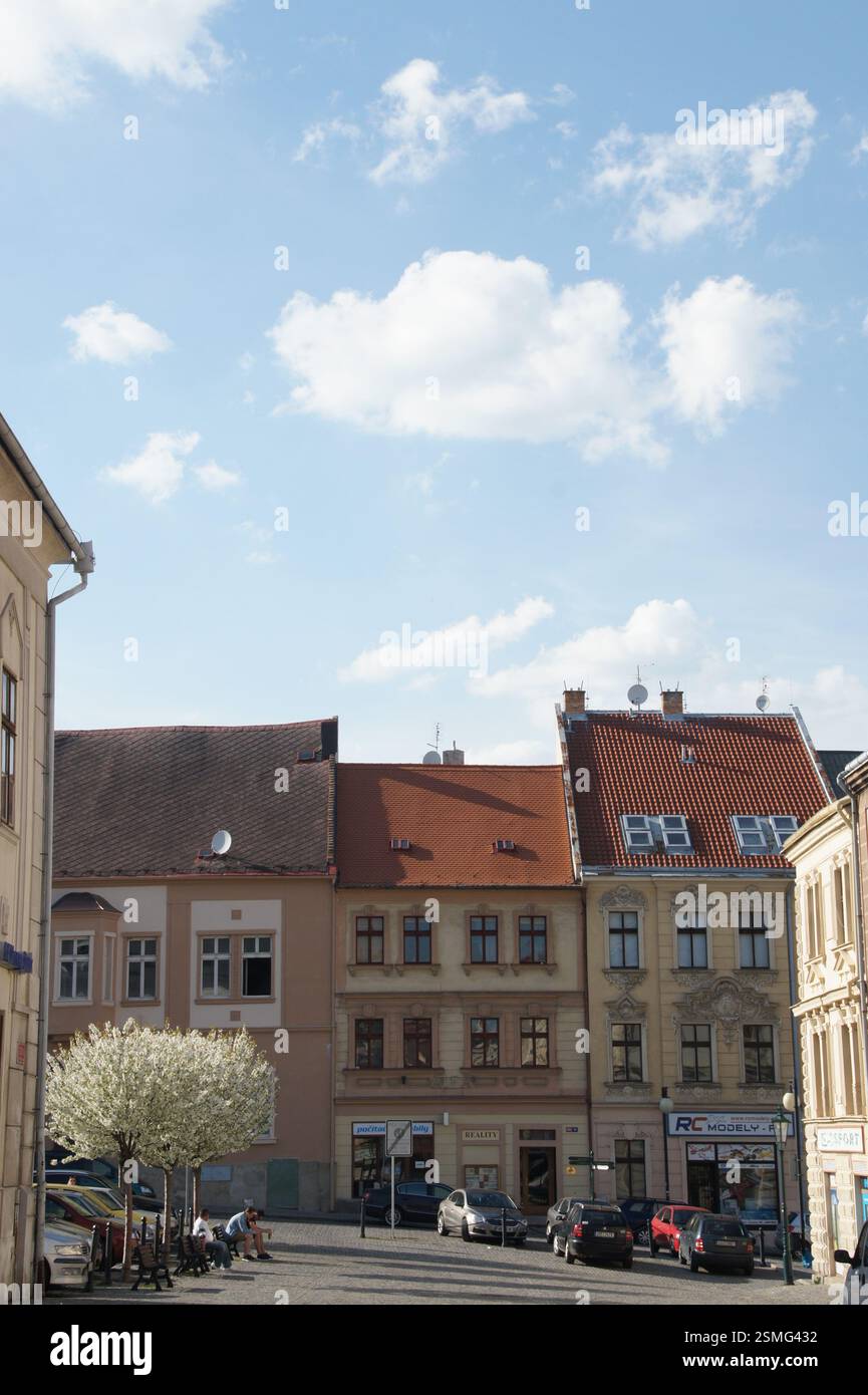A historic castle with tall spires dominates the skyline of a charming ...