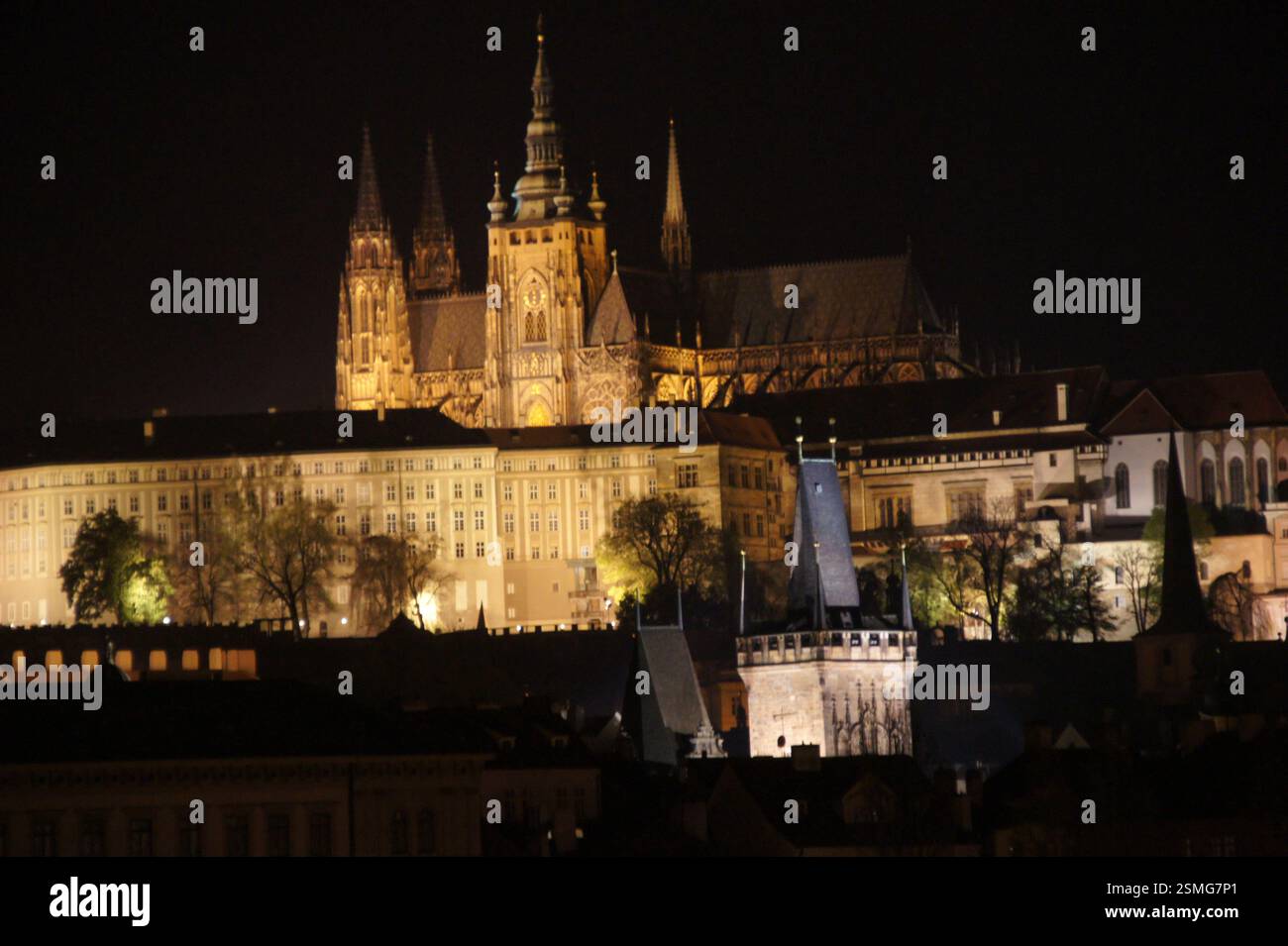 Prague Castle, a symbol of Czech history and culture, stands tall against the dark night sky ...