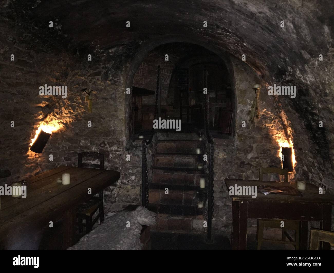 Medieval dungeon in the Czech Republic. Dark, stone walls, lit by ...