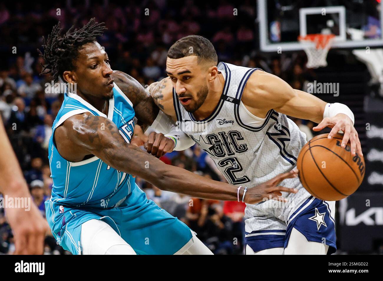 Charlotte Hornets guard Damion Baugh hits the ball out of Orlando Magic ...