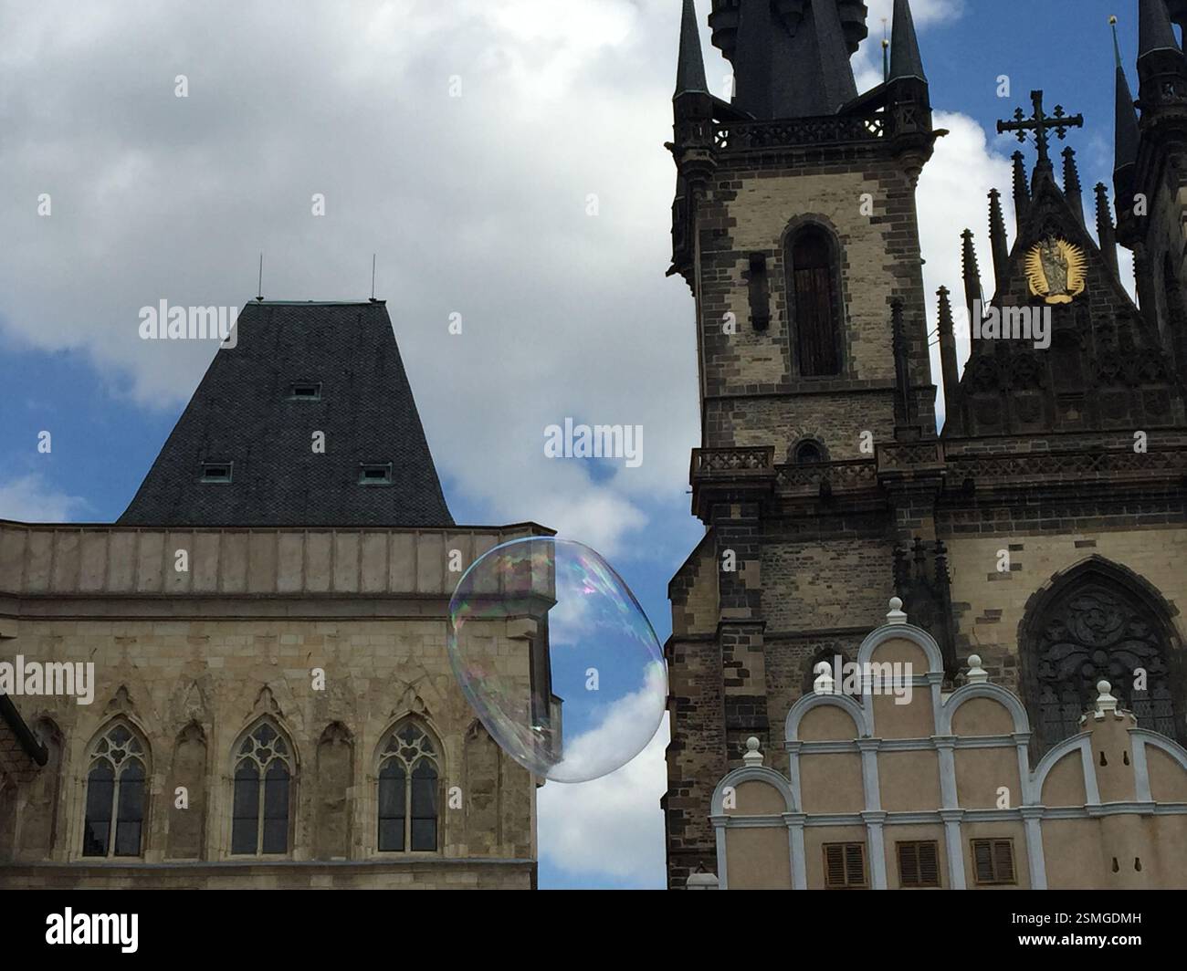 The Gothic architecture of Týn Church reflects in the bubble, a symbol ...