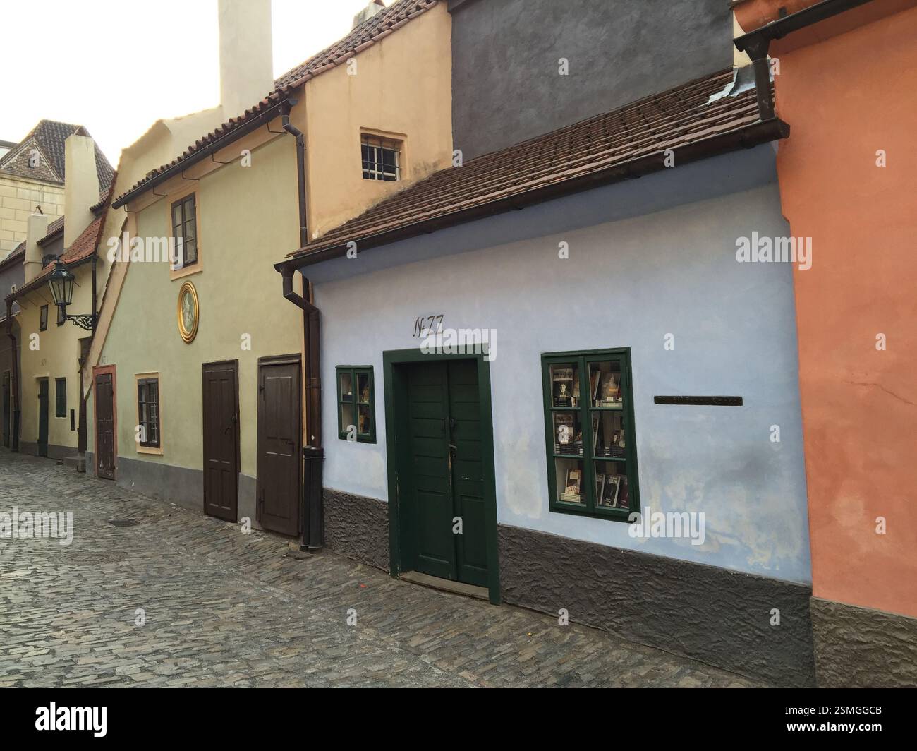 Narrow cobblestone alleyway lined with colorful historic buildings ...