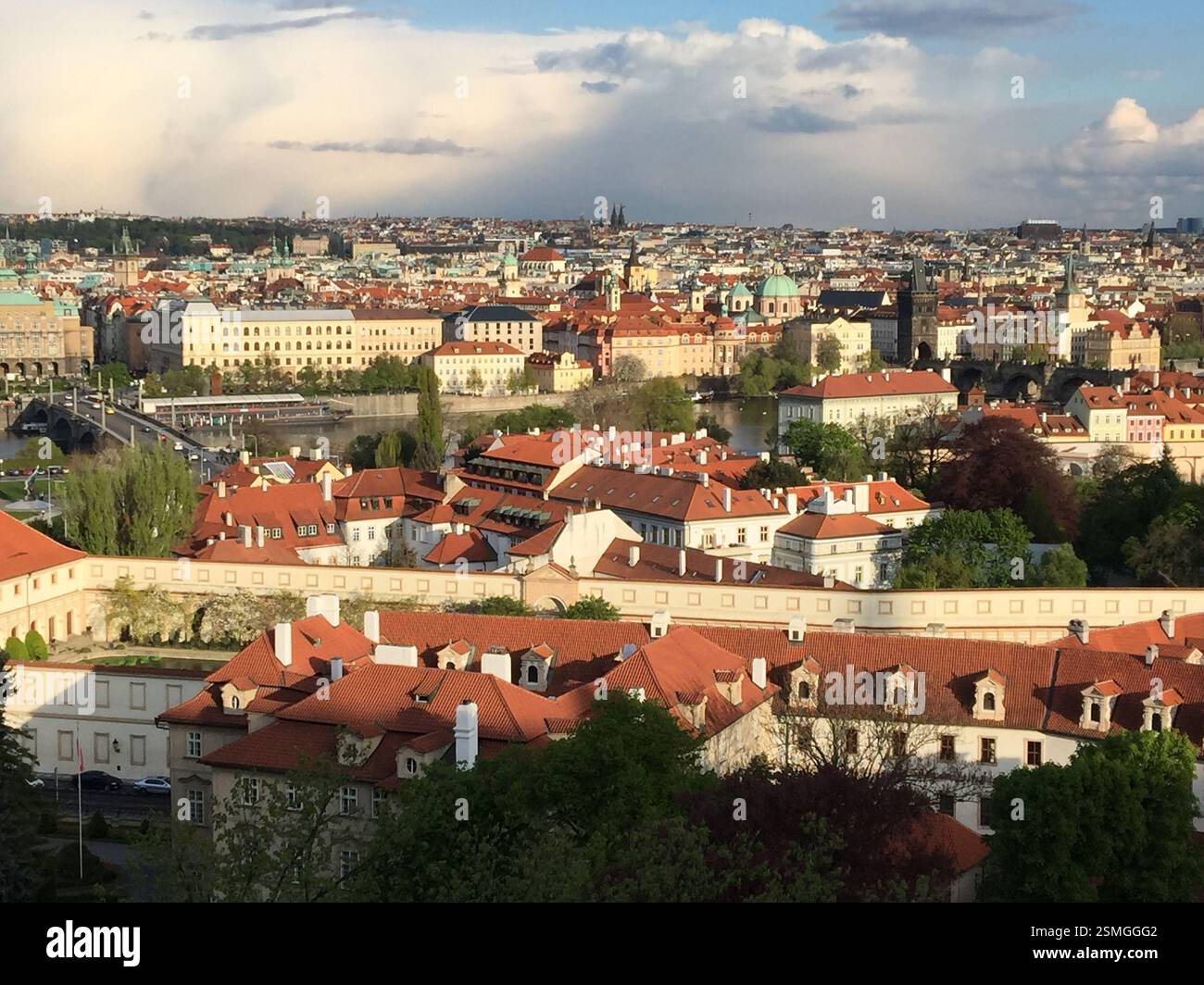 Prague Castle dominates the cityscape with its red rooftops. The ...