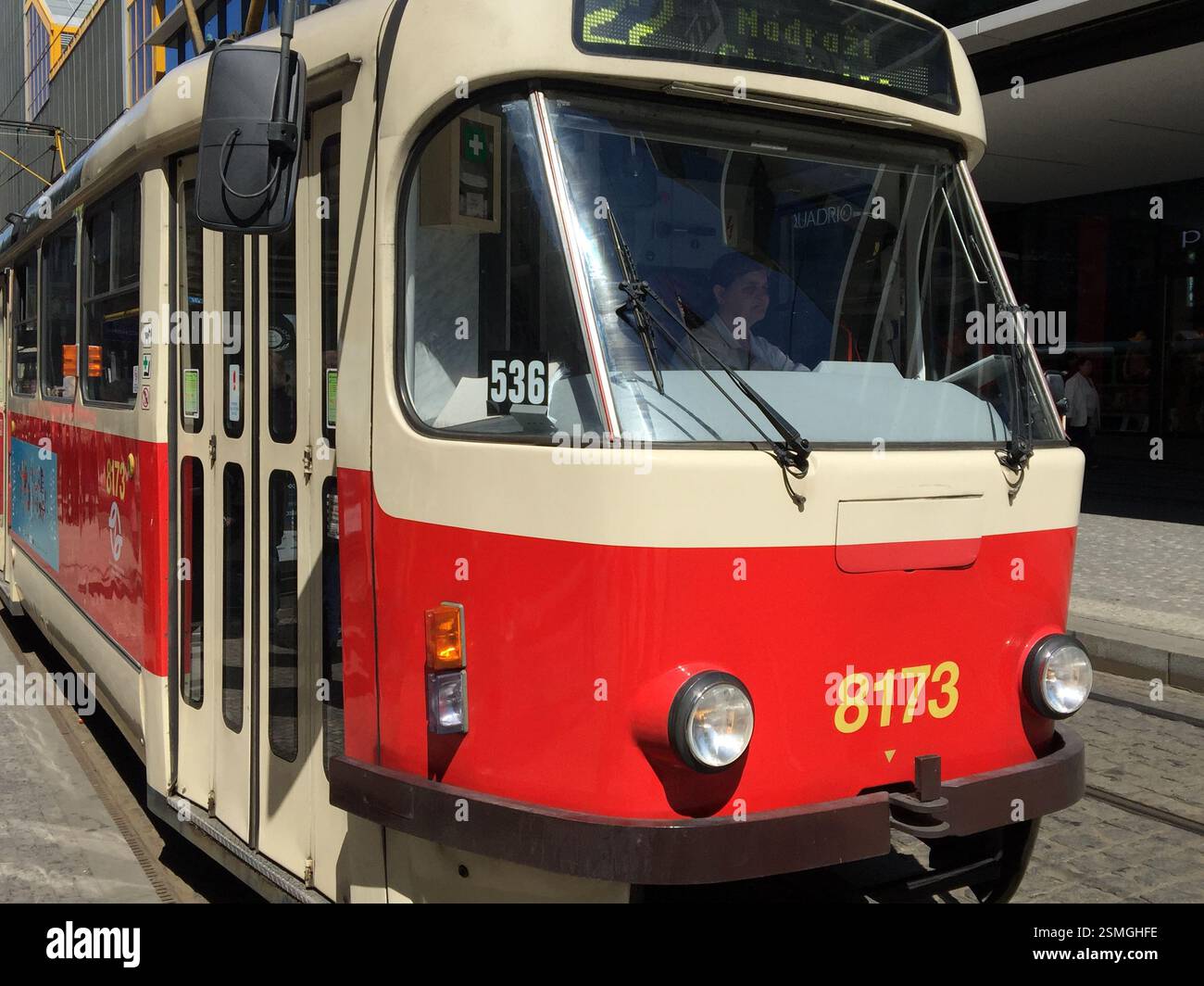 Tram 16 is a red and white tram with a QUADRIO logo and a tram stop ...