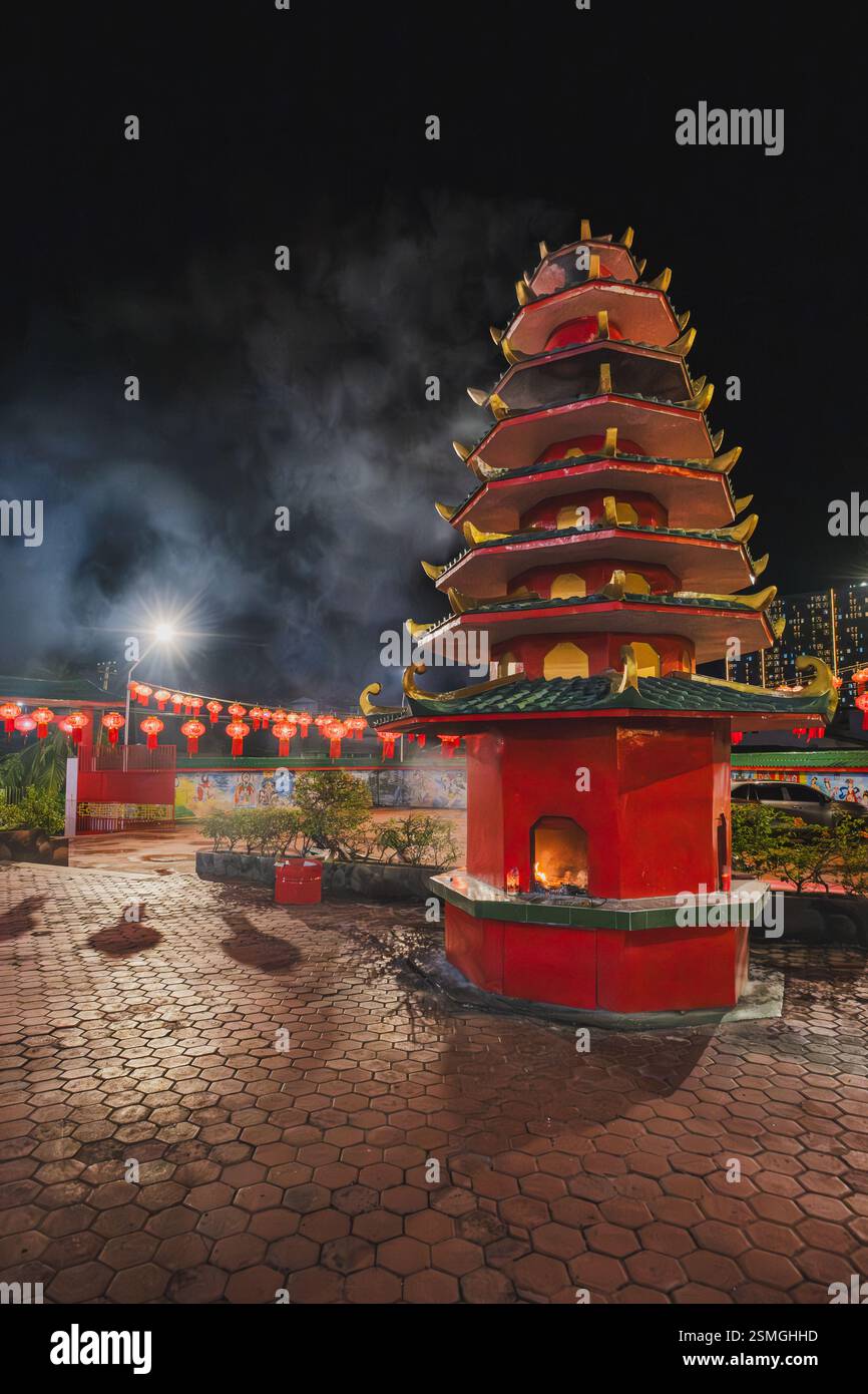 Balikpapan, Indonesia - January 28th, 2025. The pagoda emits smoke from ...