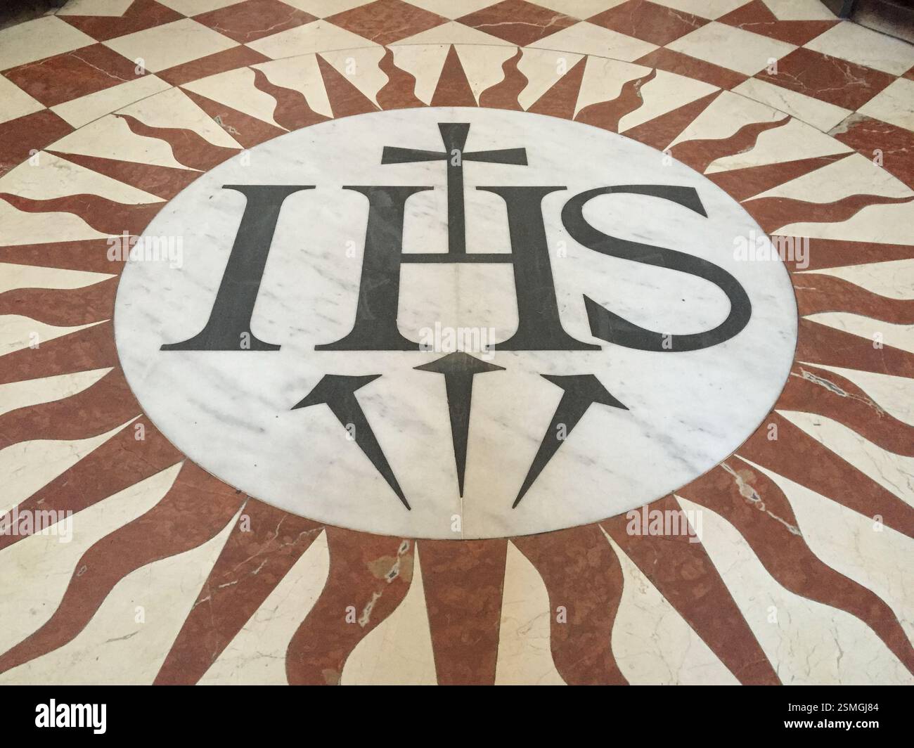 Circular emblem with radiating sun design and centered monogram ...
