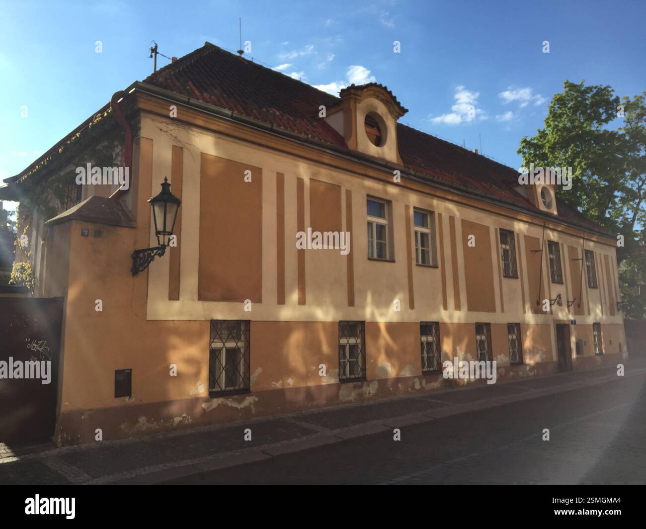 Prague, Czech Republic. A charming yellow stucco building with white ...
