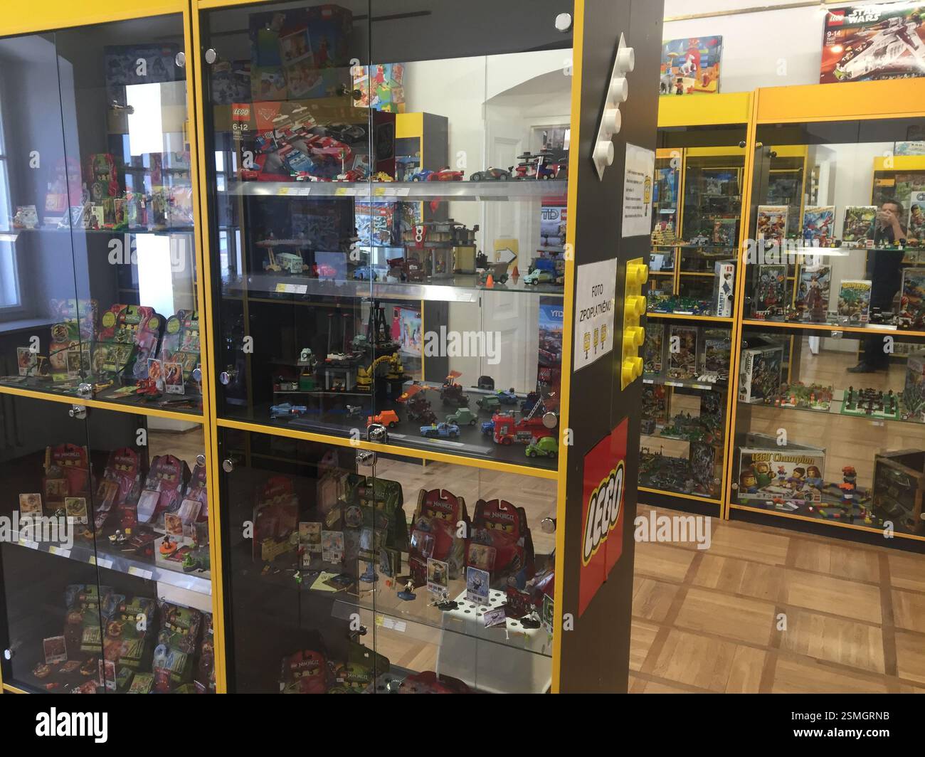 Toy store in the Czech Republic. Shelves filled with LEGO sets and other toys. Display cases ...