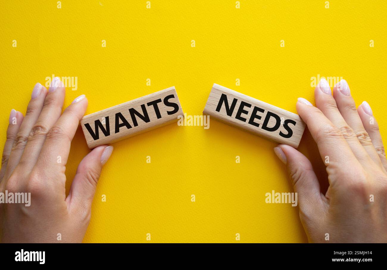 Wants and Needs symbol. Concept word Wants and Needs on wooden blocks ...