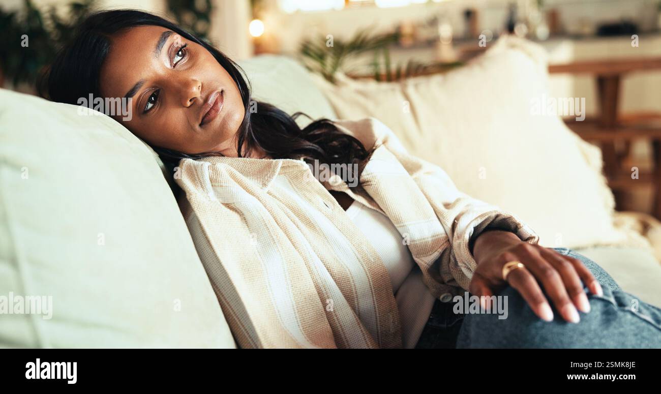 House, thinking and sad woman on sofa, depression and mental health ...