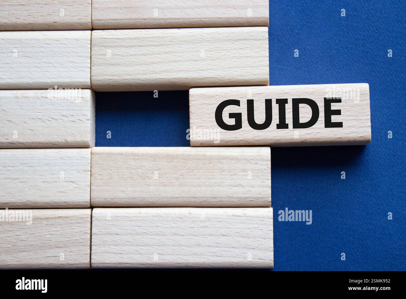 Guide symbol. Concept word Guide on wooden blocks. Beautiful deep blue ...
