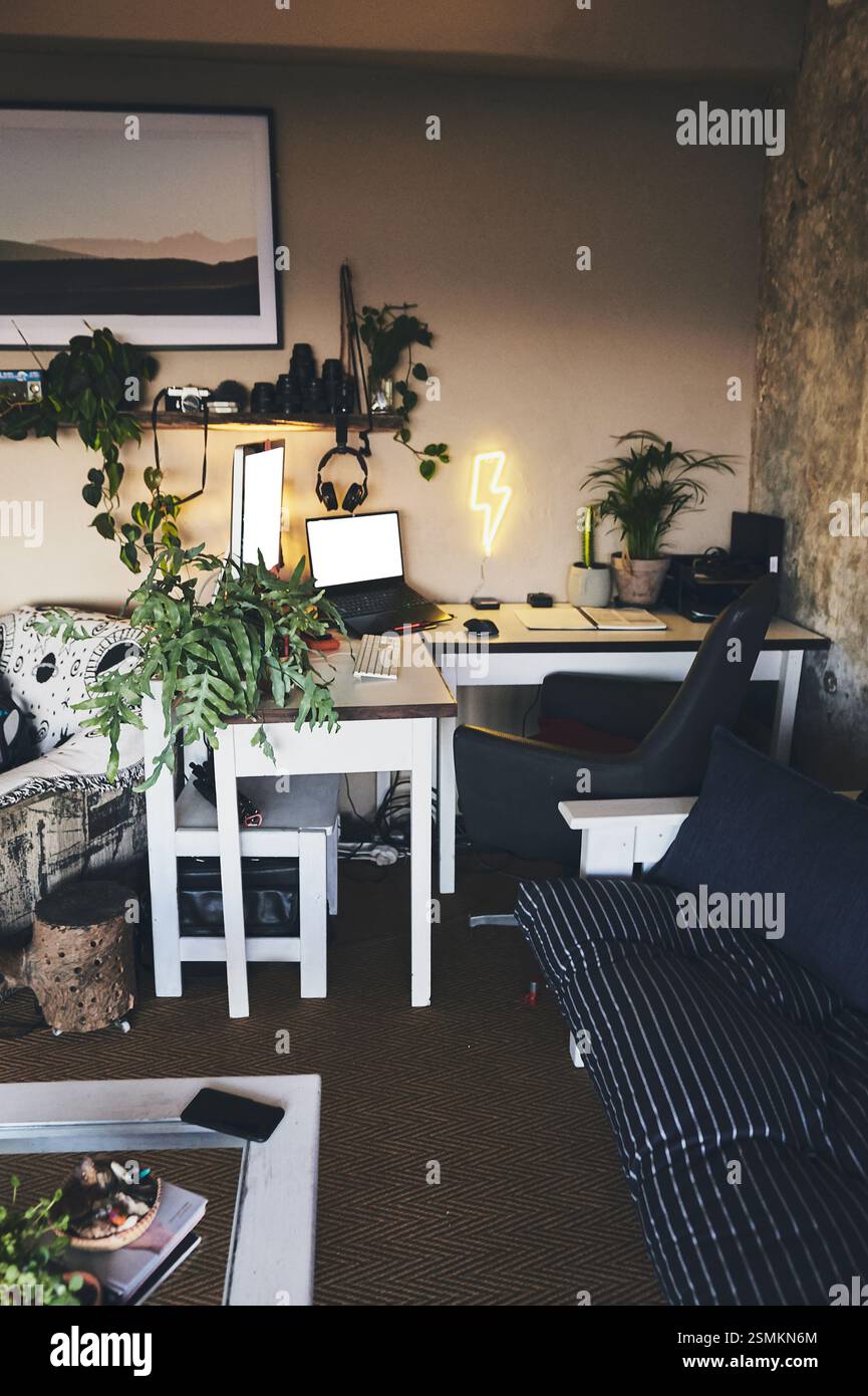 Couch, home office and laptop on desk for interior design, remote work ...