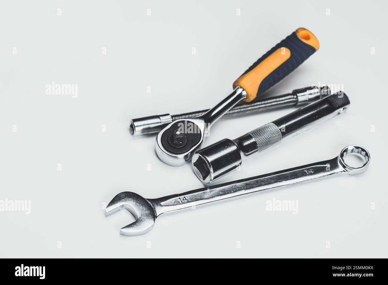 Different types of hand tools arranged for mechanical tasks on a light ...
