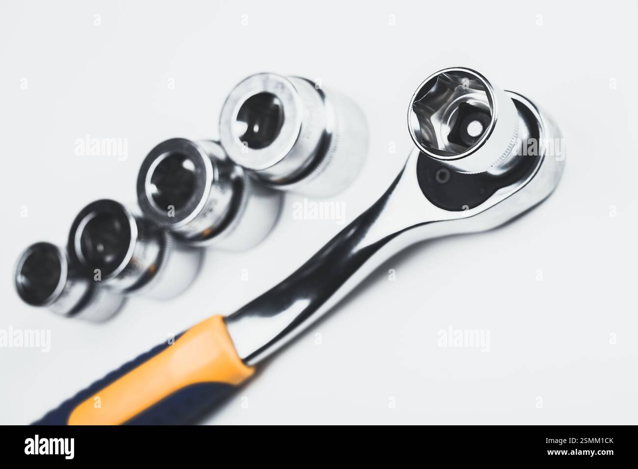Socket wrench set displayed on a white surface with multiple ...