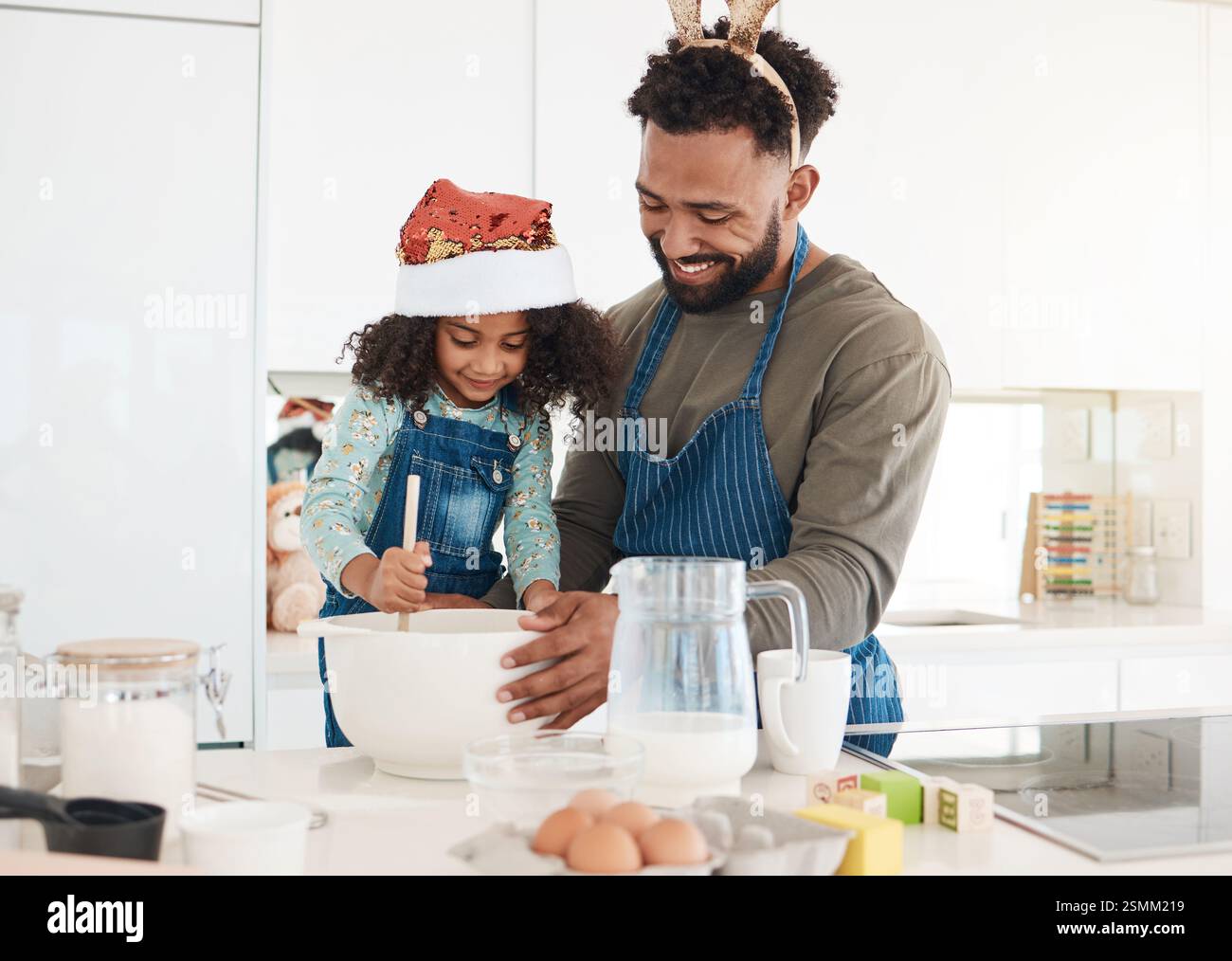 Christmas, dad and daughter with baking in kitchen for learning cake ...