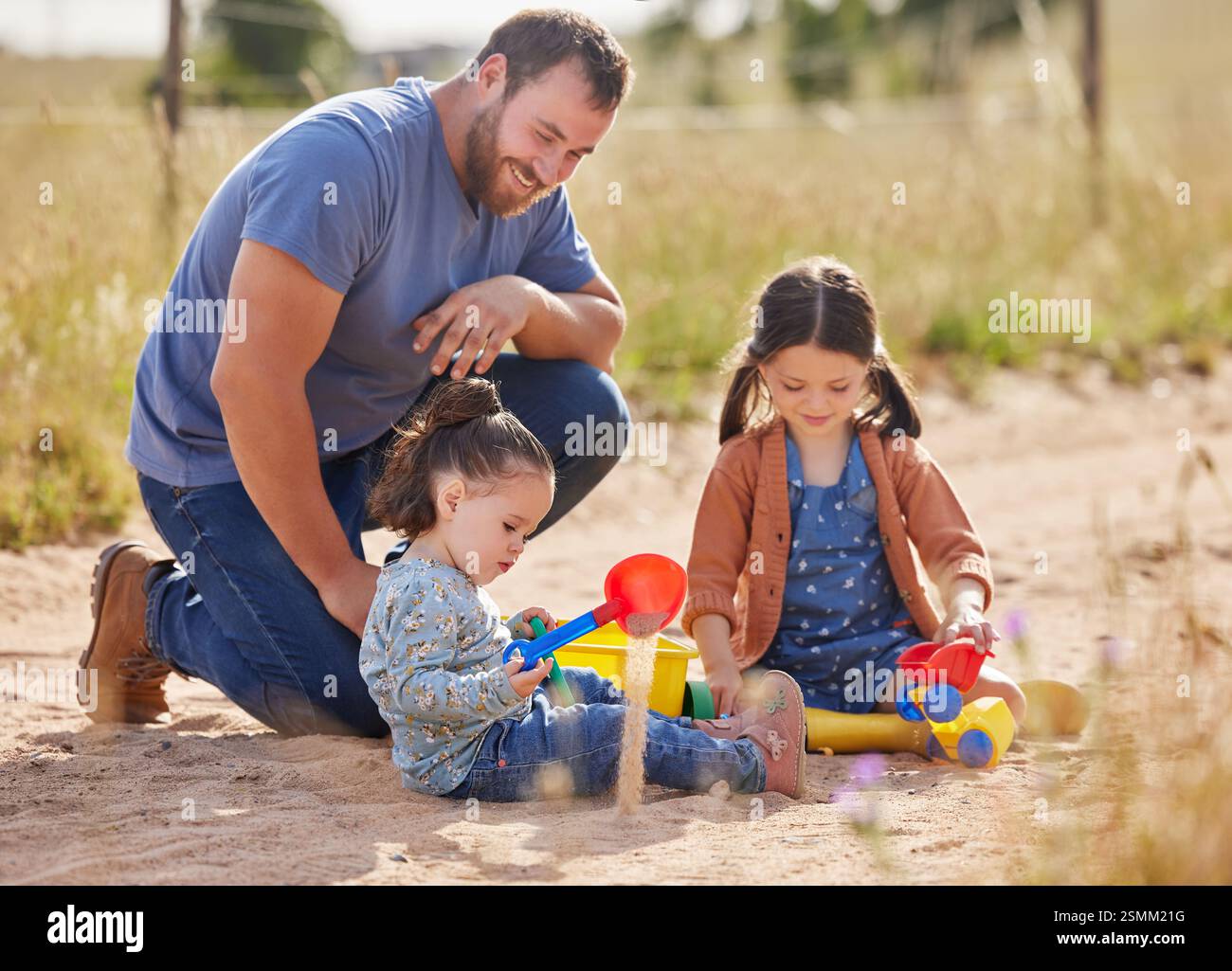 Father, children and playing with toys in sand for bonding together, curious learning or ...