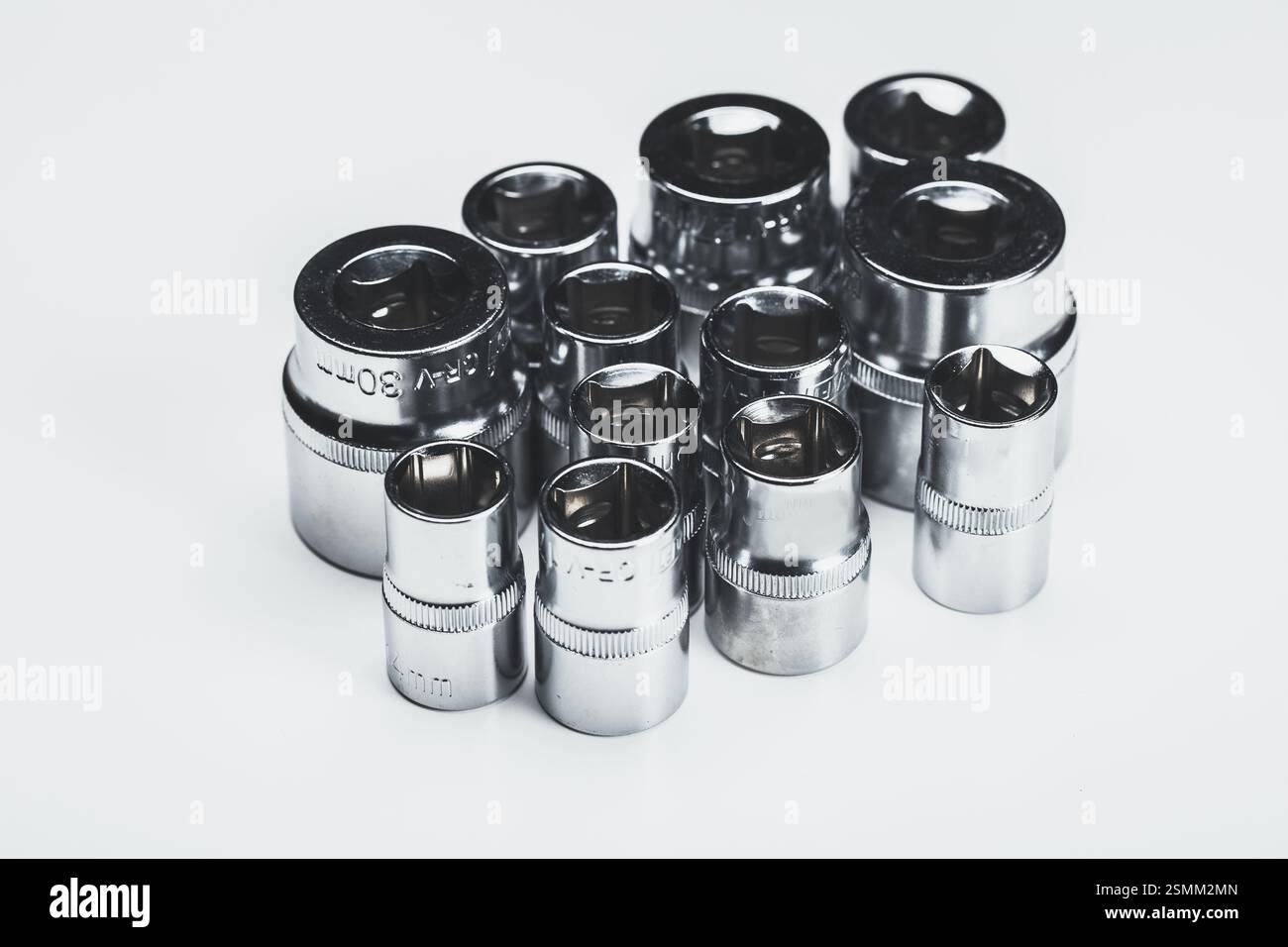 Collection of chrome socket tools arranged on a neutral background for ...