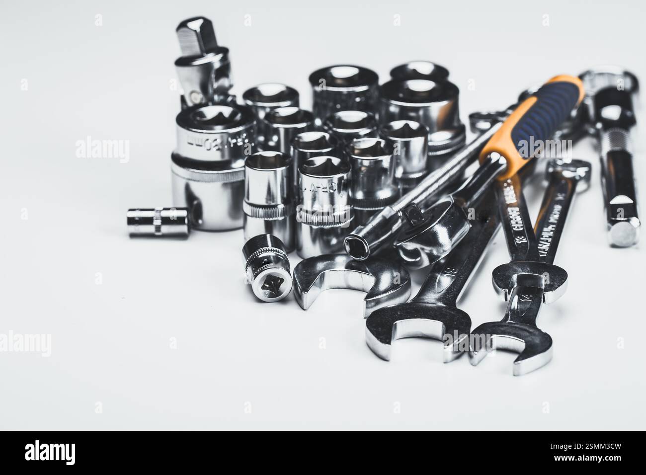 Various tools laid out for a mechanical task on a plain surface ...